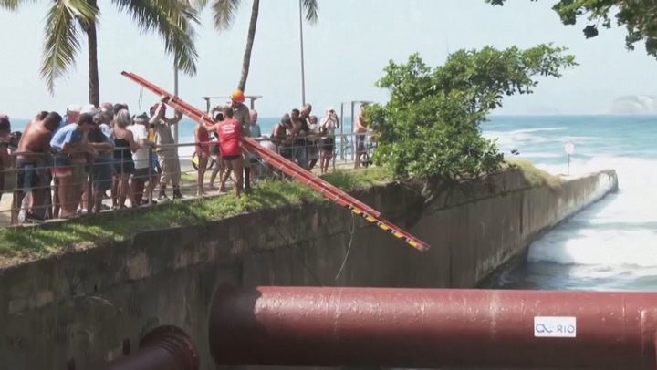 National Post | Firefighters In Rio Rescue Man Watching Big Waves